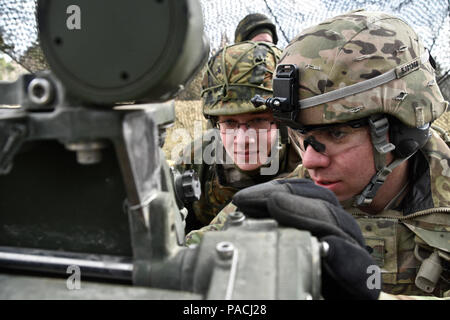 Spc. Julio Guerra (right,) a cannon crewmember assigned to Archer ...