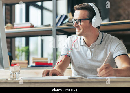 Positive smart man taking notes Stock Photo - Alamy