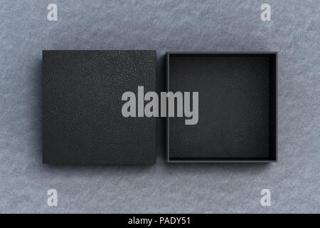 Two black leather square boxes opened and closed on black background ...
