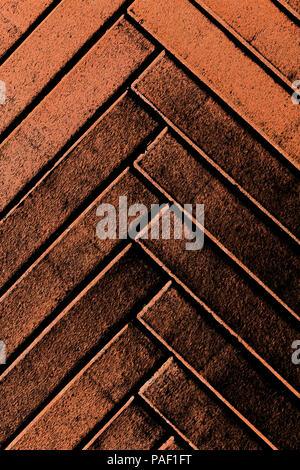 Herringbone brick pattern with red and brown bricks, showcasing a ...