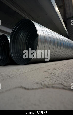 Galvanised steel ducting tubing for air extraction on the floor of a ...