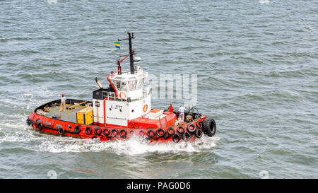 LIBREVILLE, GABON - MAR 6, 2013: Small boat sails near the port of ...