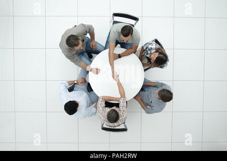 top view. handshake colleagues at the round table Stock Photo - Alamy