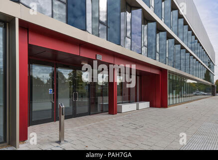 Oblique view of entrance facade with metal screen at dusk. House in ...