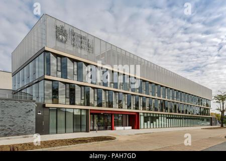 Oblique view of entrance facade with metal screen at dusk. House in ...