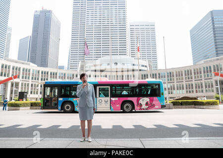 A public bus decorated with illustrations of the official mascots for ...