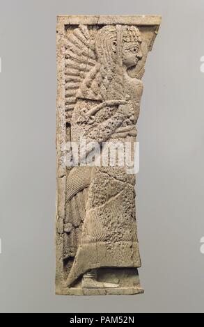 Assyrian relief sculpture panel of Tribute bearers, the first one has a ...