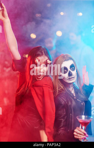 Women in creepy costumes dancing at Halloween party Stock Photo - Alamy