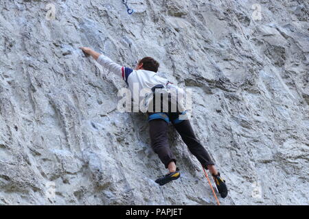 A climber ascends Malham Cove in the Yorkshire Dales National Park ...