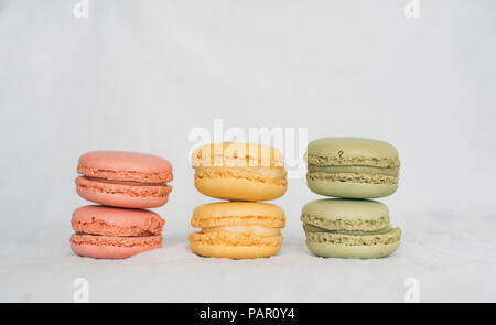 Colorful rows macarons on vintage pink pastel background Stock Photo ...