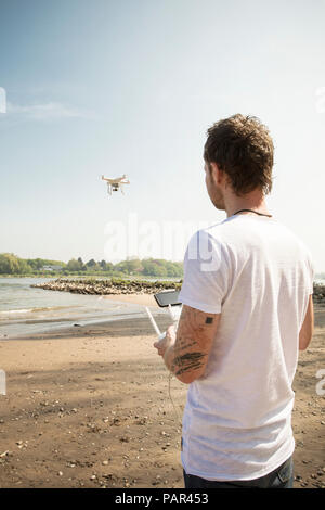 Man flying drone at a river Stock Photo - Alamy