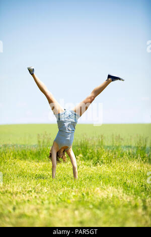 Young woman doing a handstand Stock Photo - Alamy