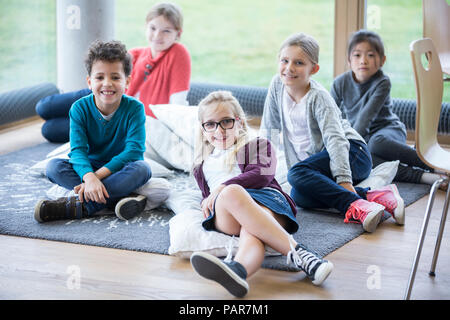 Portrait of elementary school pupils sitting at their desks Stock Photo ...
