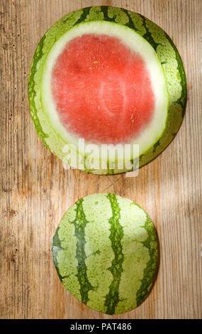 Green melon on wood background Stock Photo - Alamy