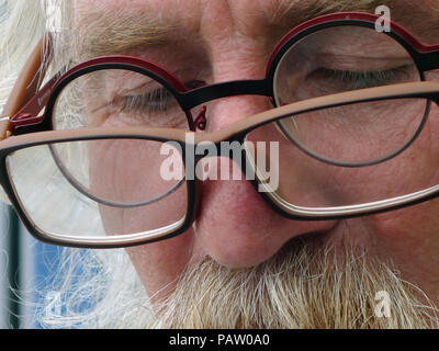 Really closeup of Silver haired man wearing two pairs of glasses at the ...