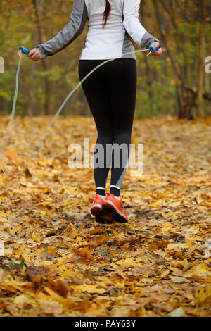Fit woman skipping rope. Girl exercising with jumping rope at home ...