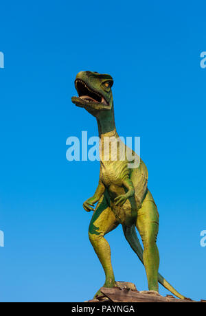 Model of Velociraptor roaring against blue sky Stock Photo - Alamy