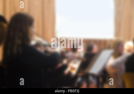 Artists symphony orchestra. abstract blurred image. Musician plays a ...