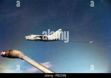An air to air left rear view of an A-7E Corsair II aircraft trailing a ...