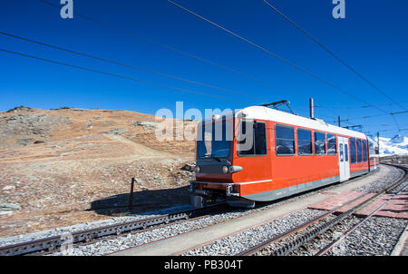 red tram or train on rail to Matterhorn, popular Alps peak at Zermatt ...