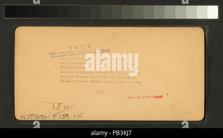 Group of natives eating poi (in front of thatched hut), Hawaiian ...
