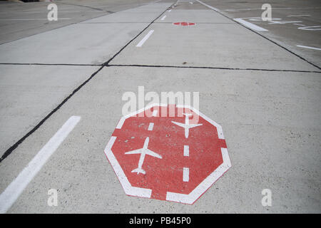 Traffic sign painted on the taxiway on the runway of an international ...