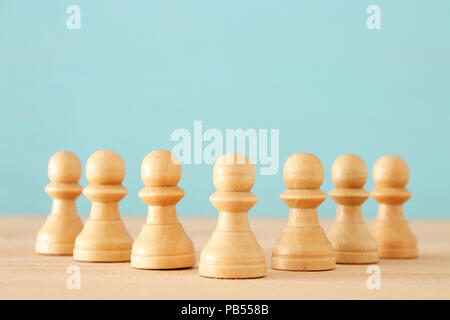 image of wooden chess ponds over table ,building a strong team, human ...