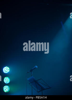 Blue stage with microphone and spotlight Stock Photo - Alamy