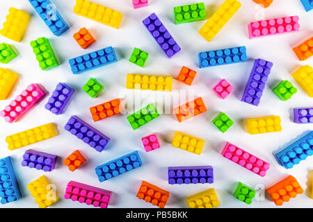 Colorful plastic building blocks flat lay on white background. Child ...
