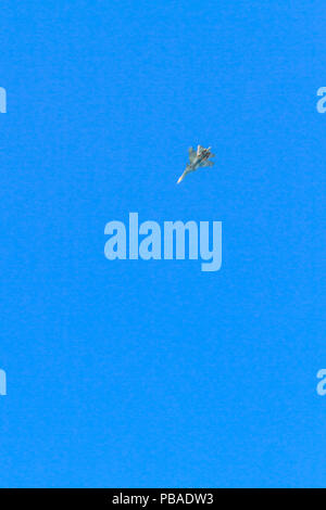 Military fighter jet far in blue sky Stock Photo - Alamy