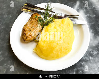 Traditional schnitzel with potato mash and green salad served on a ...