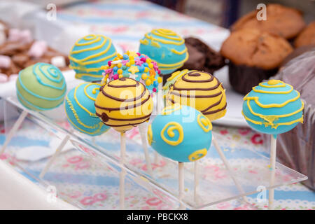 Variety of colorful hand made lollipops on a stand in a London market ...