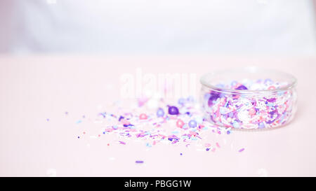 Colorful purple sprinkle blend on a white background Stock Photo - Alamy
