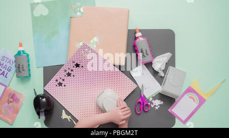 Decorating present for kids birthday with craft paper Stock Photo - Alamy