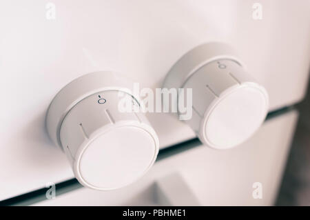 Control knobs of a white electric stove close-up Stock Photo - Alamy