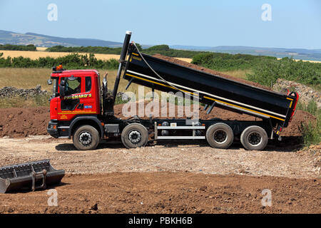 Anew tipper lorry delivering its full load of fresh earth during ...