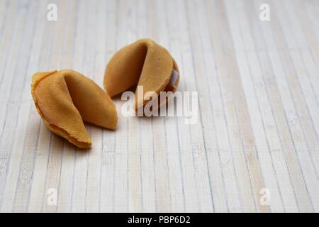 Fortune cookies on a bamboo mat with chopsticks and a fortune Stock ...