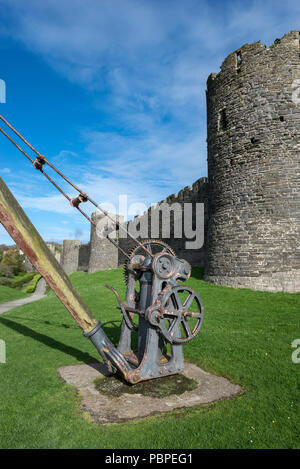 Old lifting gear beside the medieval stone walls at Conwy, North Wales ...