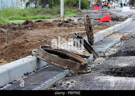 Preparation for installation of sewer hatches on the new road repair ...