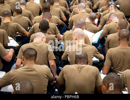 GREAT LAKES, Ill. (July 24, 2018) Recruits stand in line to receive ...