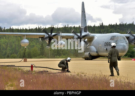 Marines prepare to refuel an Army UH-60 Black Hawk from a USMC C-130 ...