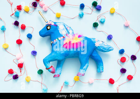 Kids craft. Painted blue and decorated with jewels and feathers paper ...