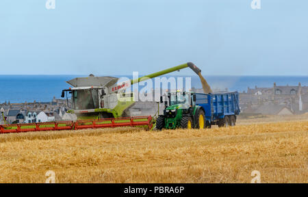 COMBINE HARVESTER CREATING CLOUDS OF DUST ON A BARLEY FIELD OVERLOOKING ...