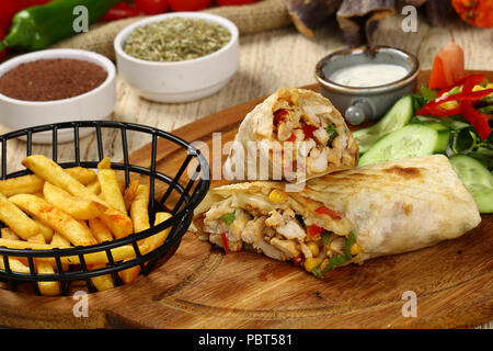 Fried chicken stuffed tortilla wrap sandwich with vegetables and french ...
