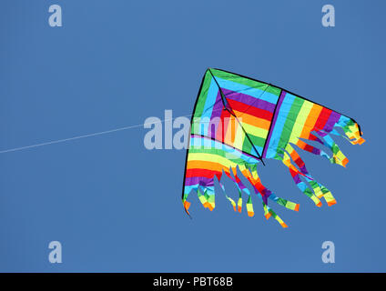 big colorful kite flies high in the sky . Beautiful kites in a kite ...
