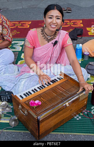 An attractive Japanese Hare Krishna devotee chants and plays the ...