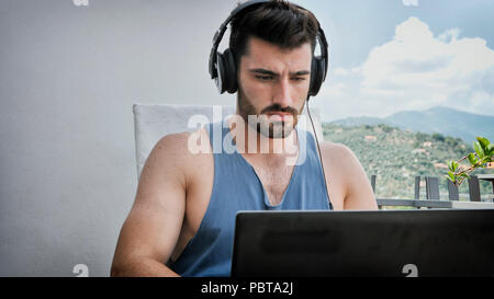 Handosme Man Working at Home at Laptop Computer Stock Photo - Alamy