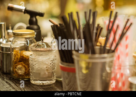 Professional cocktail tools and ingredients in glass bottles and jars ...