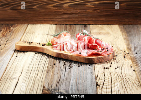 Food tray with delicious salami, coppa, fresh sausages and herbs. Meat ...