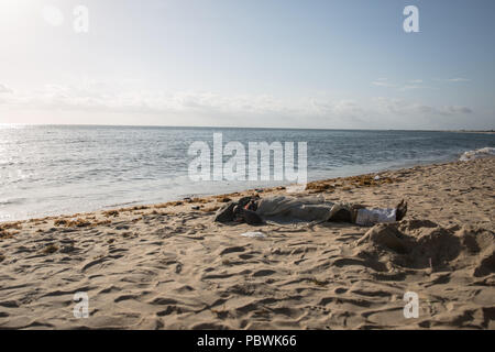 Monrovia, Liberia. 30th May, 2018. A man sifts through rubbish looking ...